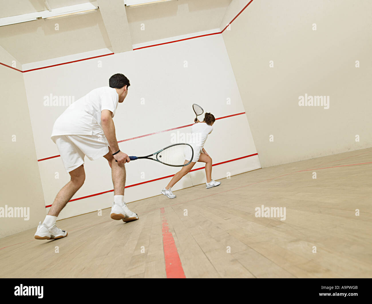 Man and woman playing squash Stock Photo - Alamy