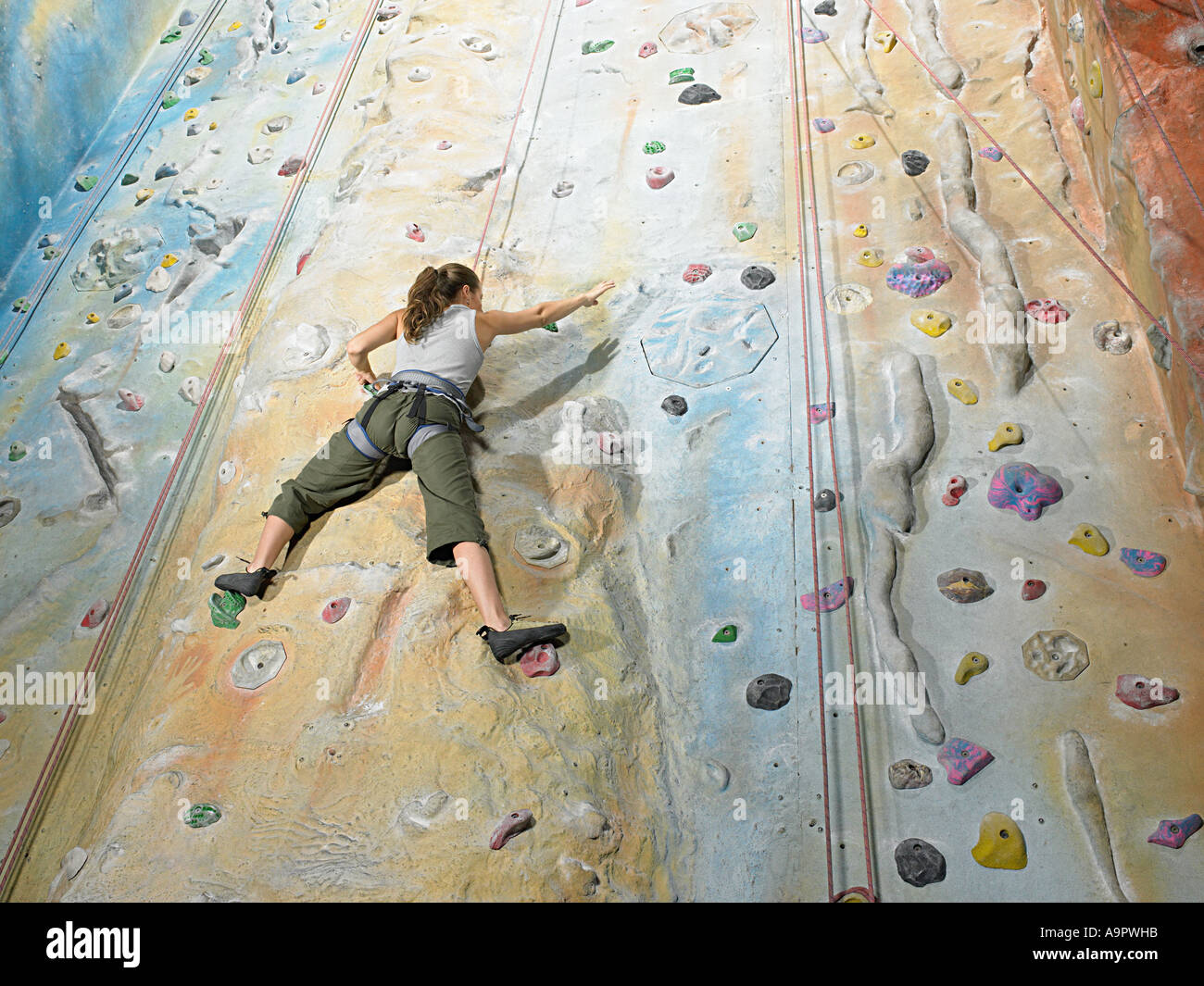 Woman on climbing wall Stock Photo - Alamy