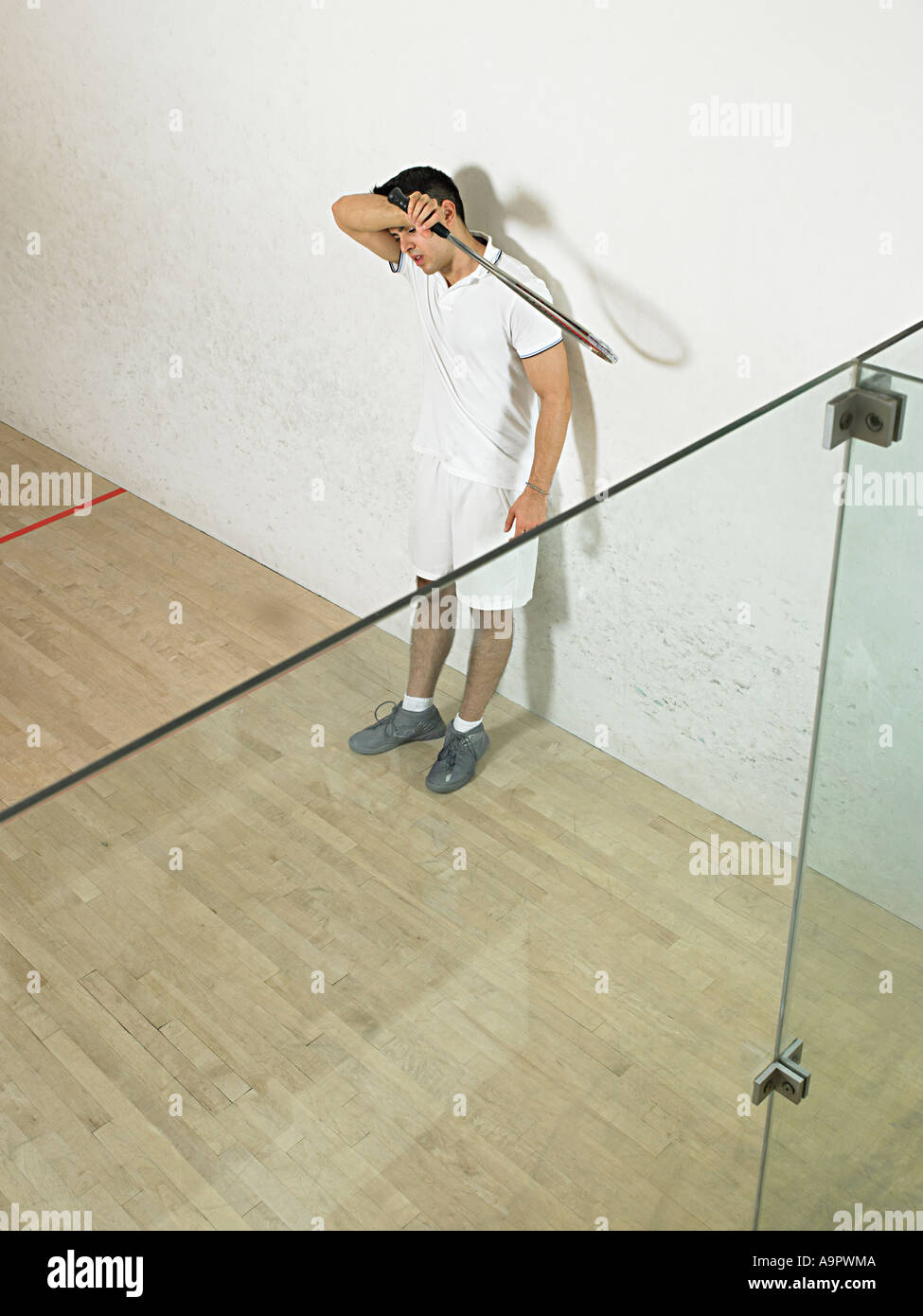 Tired squash player Stock Photo - Alamy
