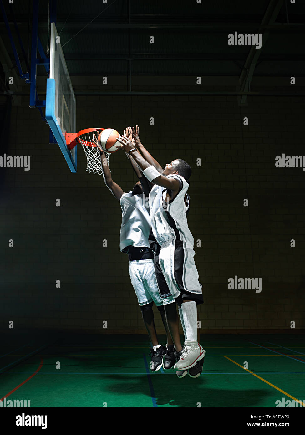 Basketball players by hoop Stock Photo - Alamy