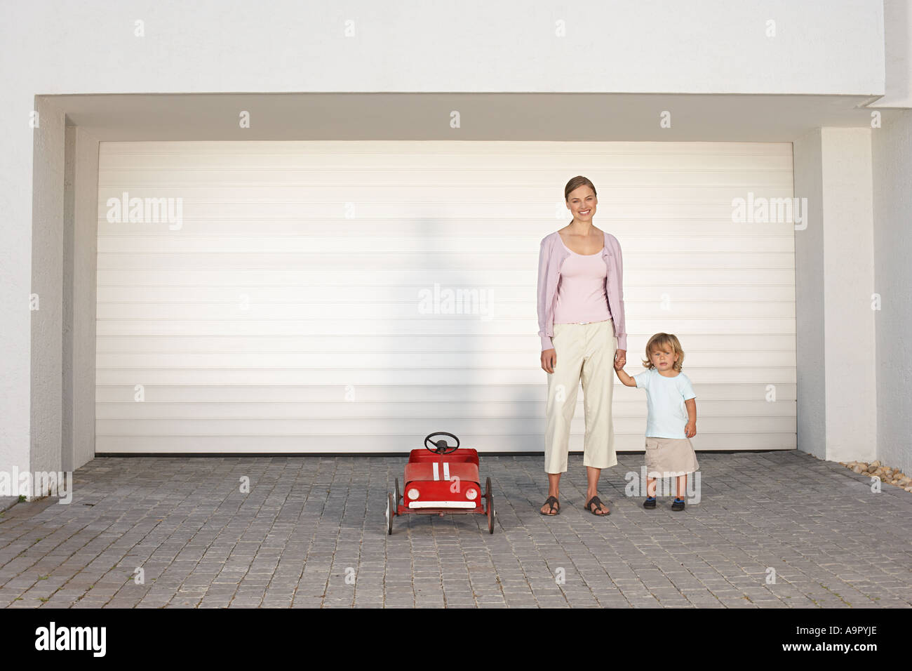 Mother and daughter stood in driveway Stock Photo - Alamy