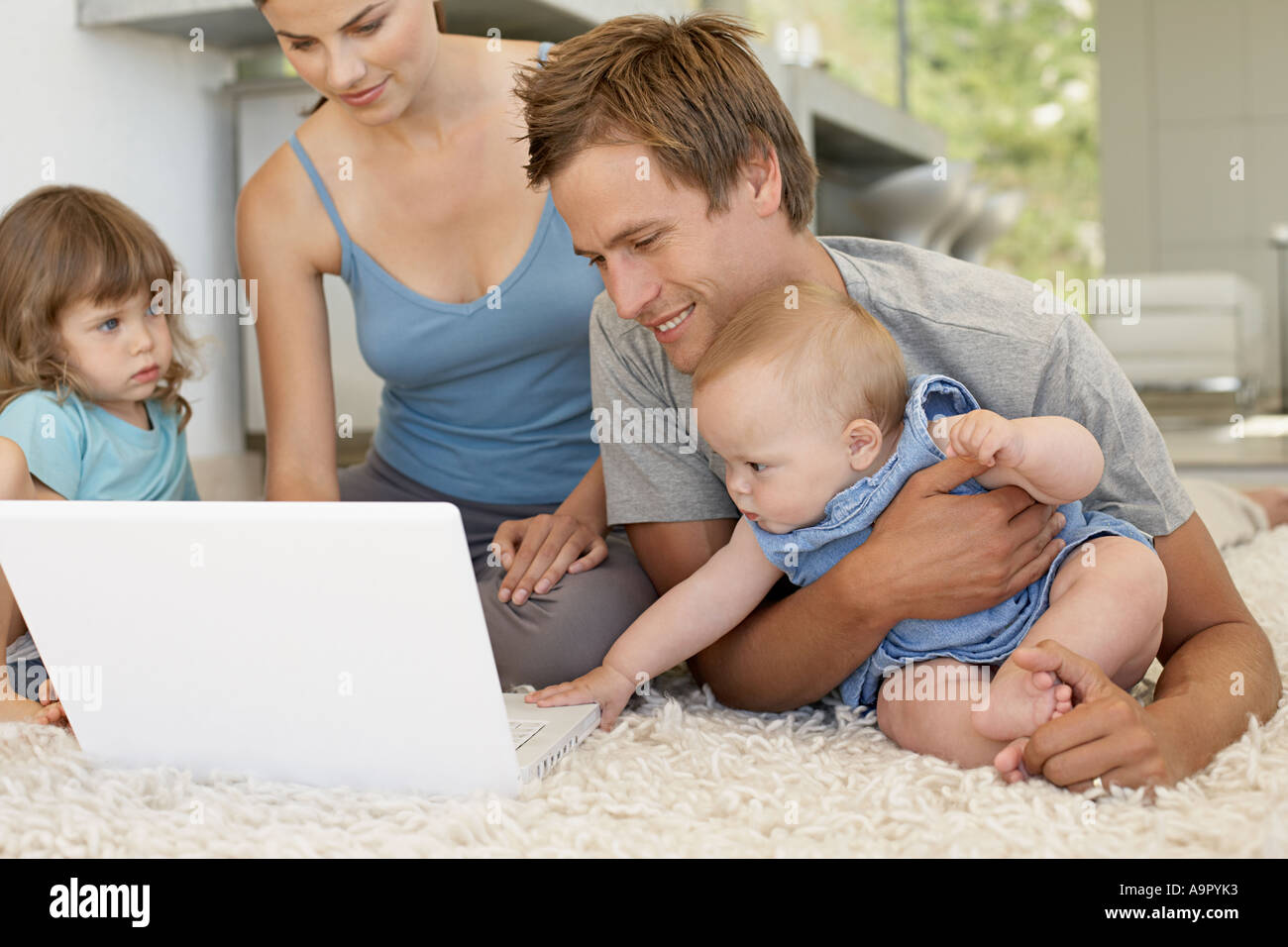 Family using a laptop computer Stock Photo - Alamy