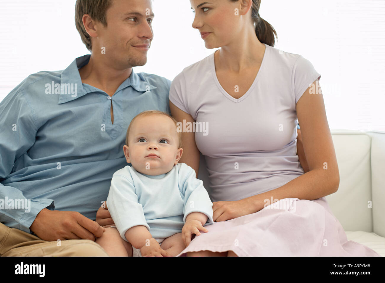 Mother father and their baby Stock Photo - Alamy