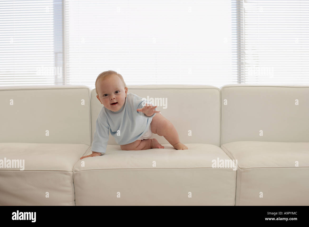Baby sat on sofa Stock Photo - Alamy