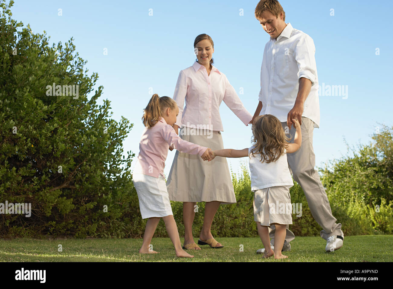 Family playing in the garden Stock Photo - Alamy