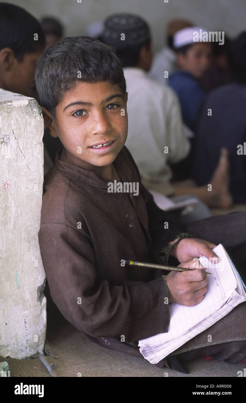 Young Afghan refugee children receiving a few hours basic education ...