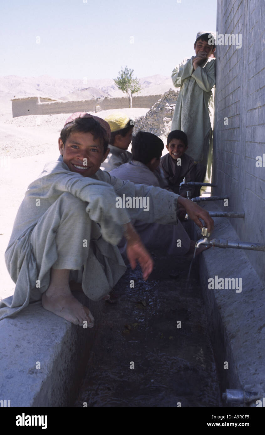 Young Pakistani boys enjoy running water for the first time in the ...