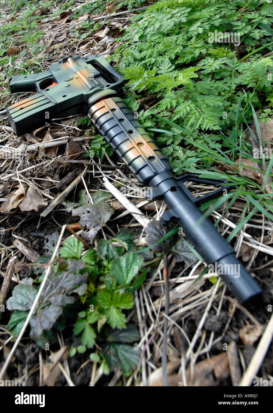 broken toy machine gun discarded on the ground Stock Photo - Alamy