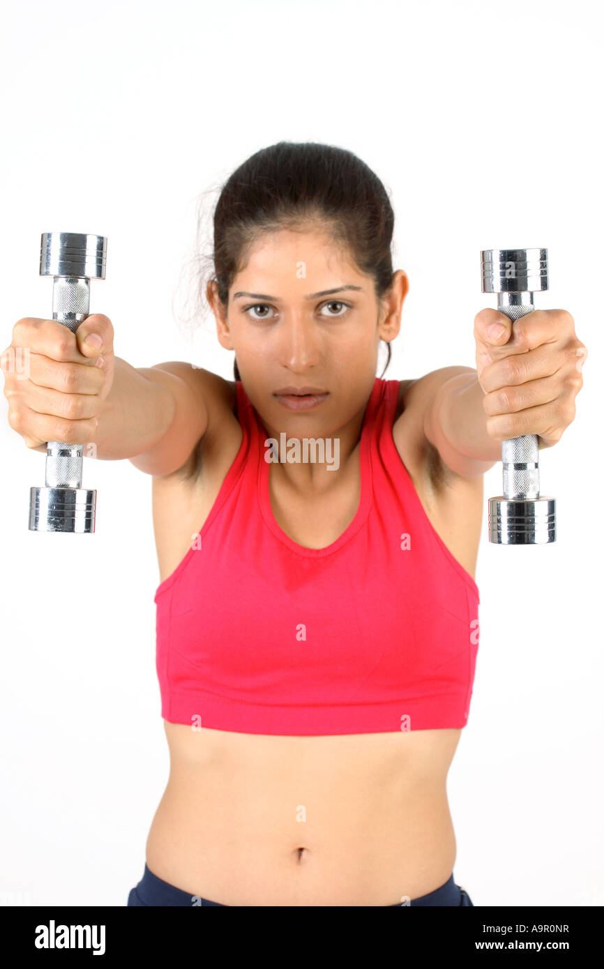 Portrait of a woman exercising with dumbbell Stock Photo - Alamy