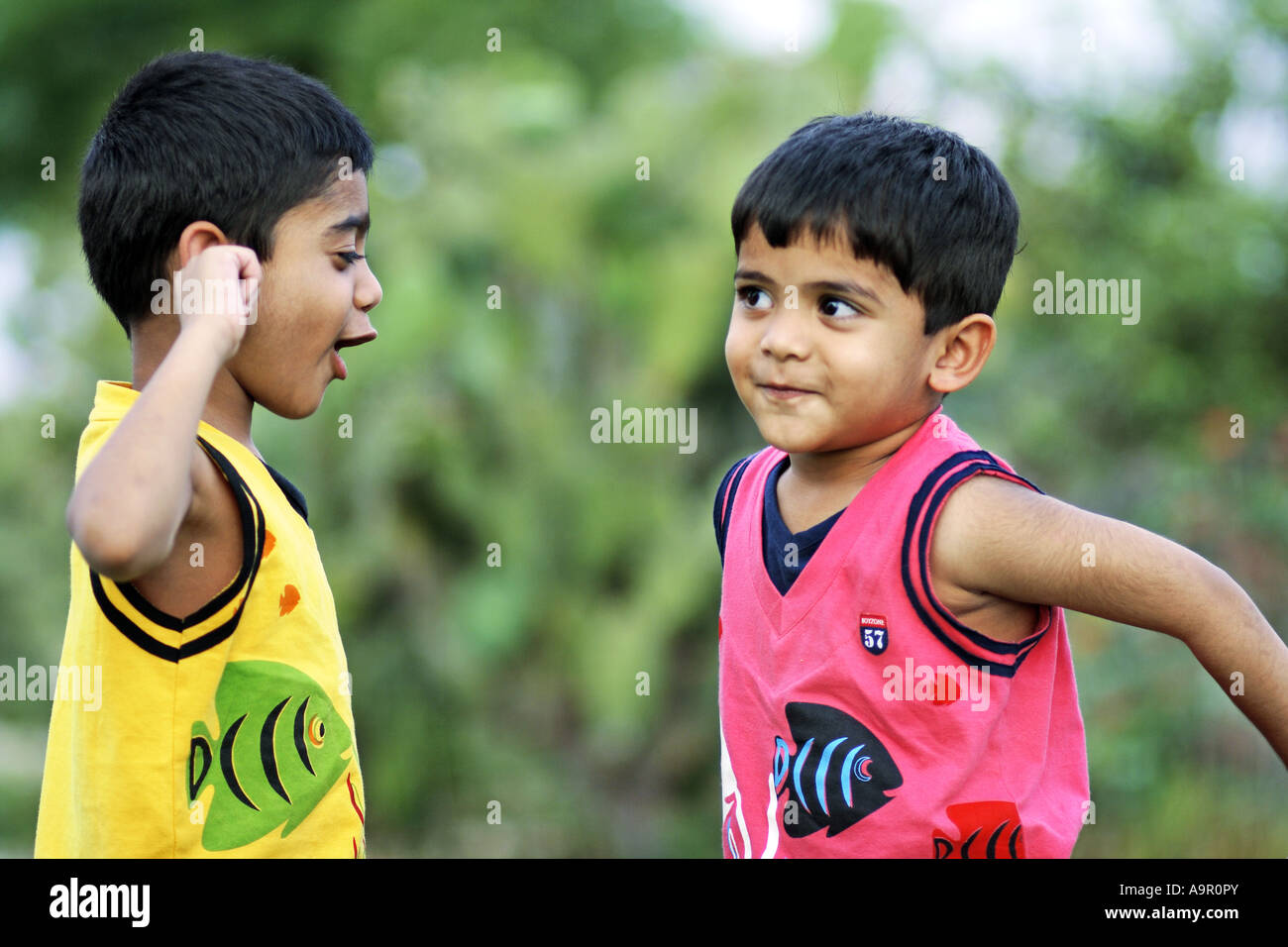 Two young kids facing each other Stock Photo - Alamy