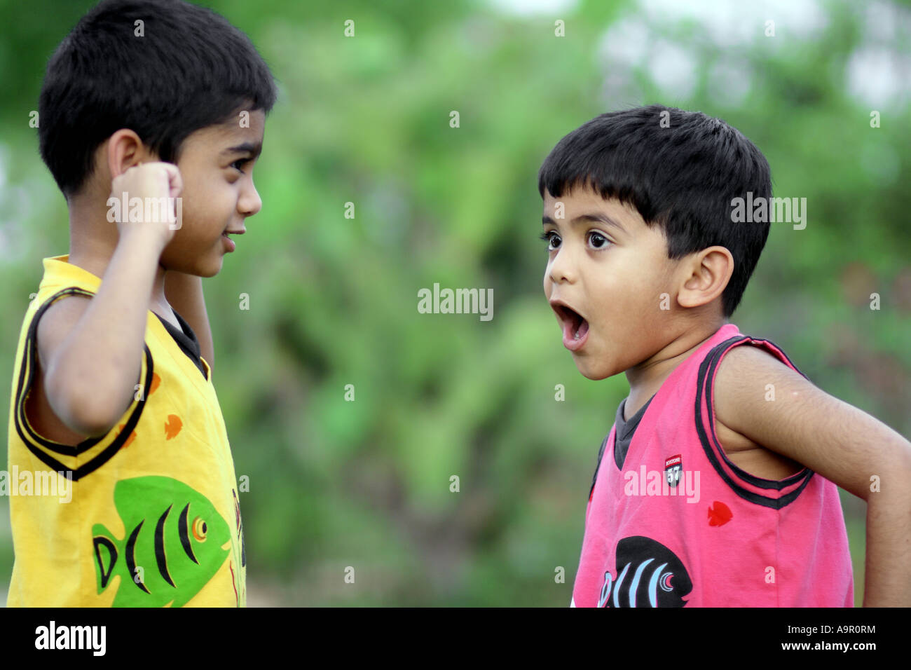 Two young kids facing each other Stock Photo - Alamy