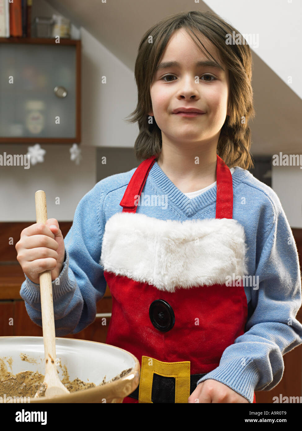 Boy with mixing bowl Stock Photo - Alamy