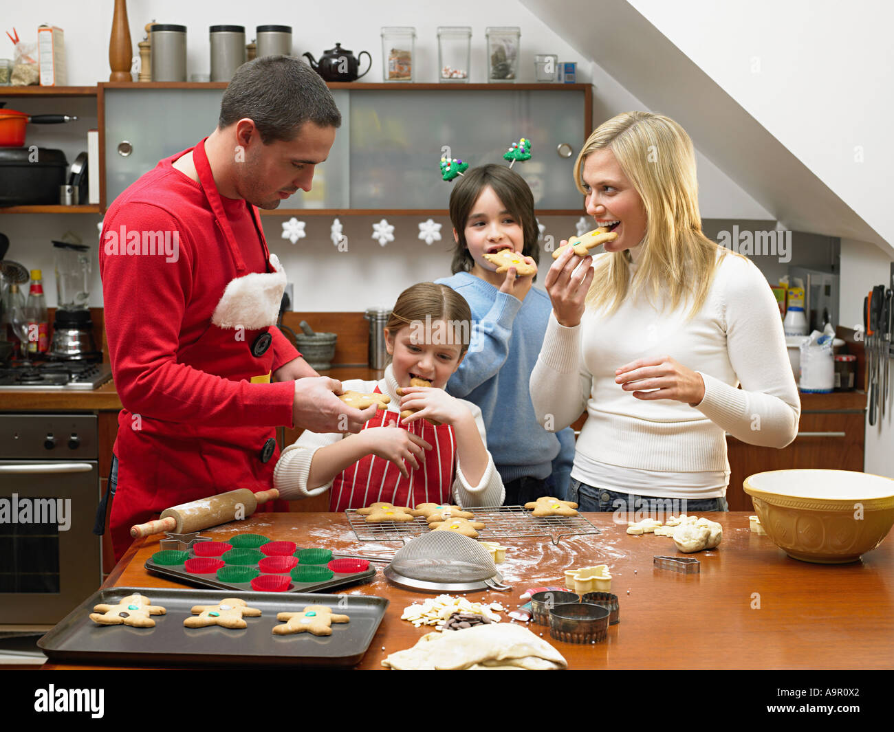 Family eating gingerbread men Stock Photo - Alamy