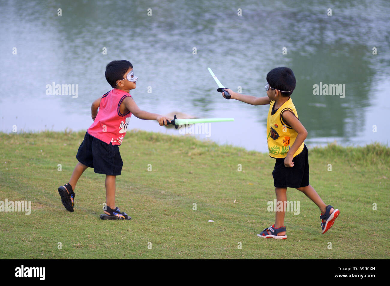 Two young boys playing in a park Stock Photo - Alamy
