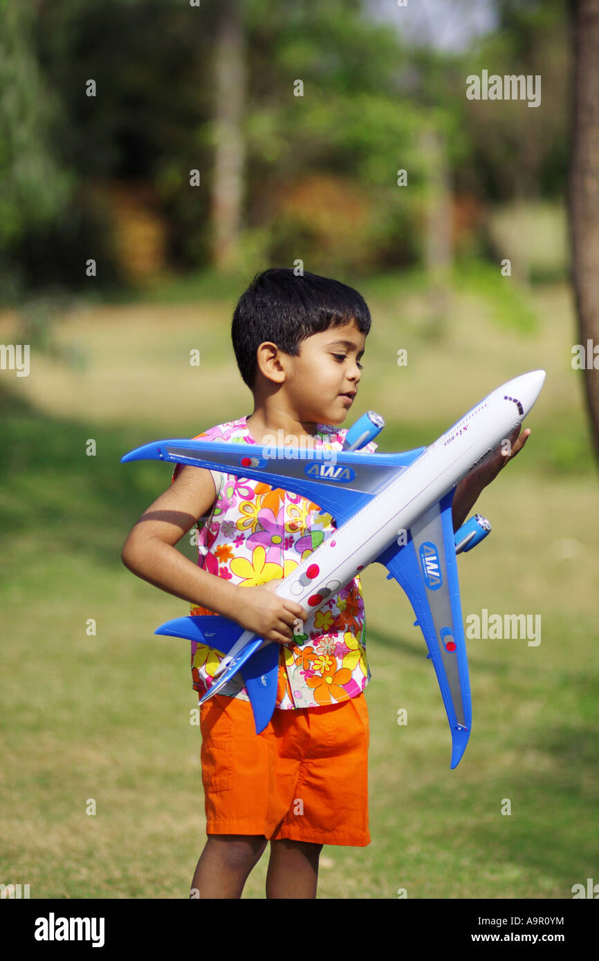 Young boy playing with a toy airplane Stock Photo - Alamy