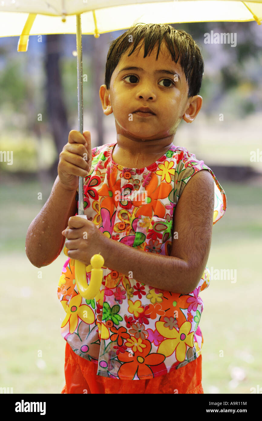 A kid holding an umbrellas Stock Photo - Alamy