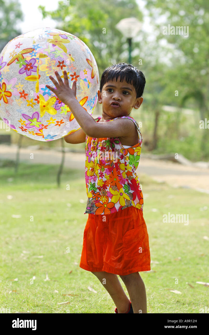 Full length portrait of a boy playing with anb airball Stock Photo - Alamy