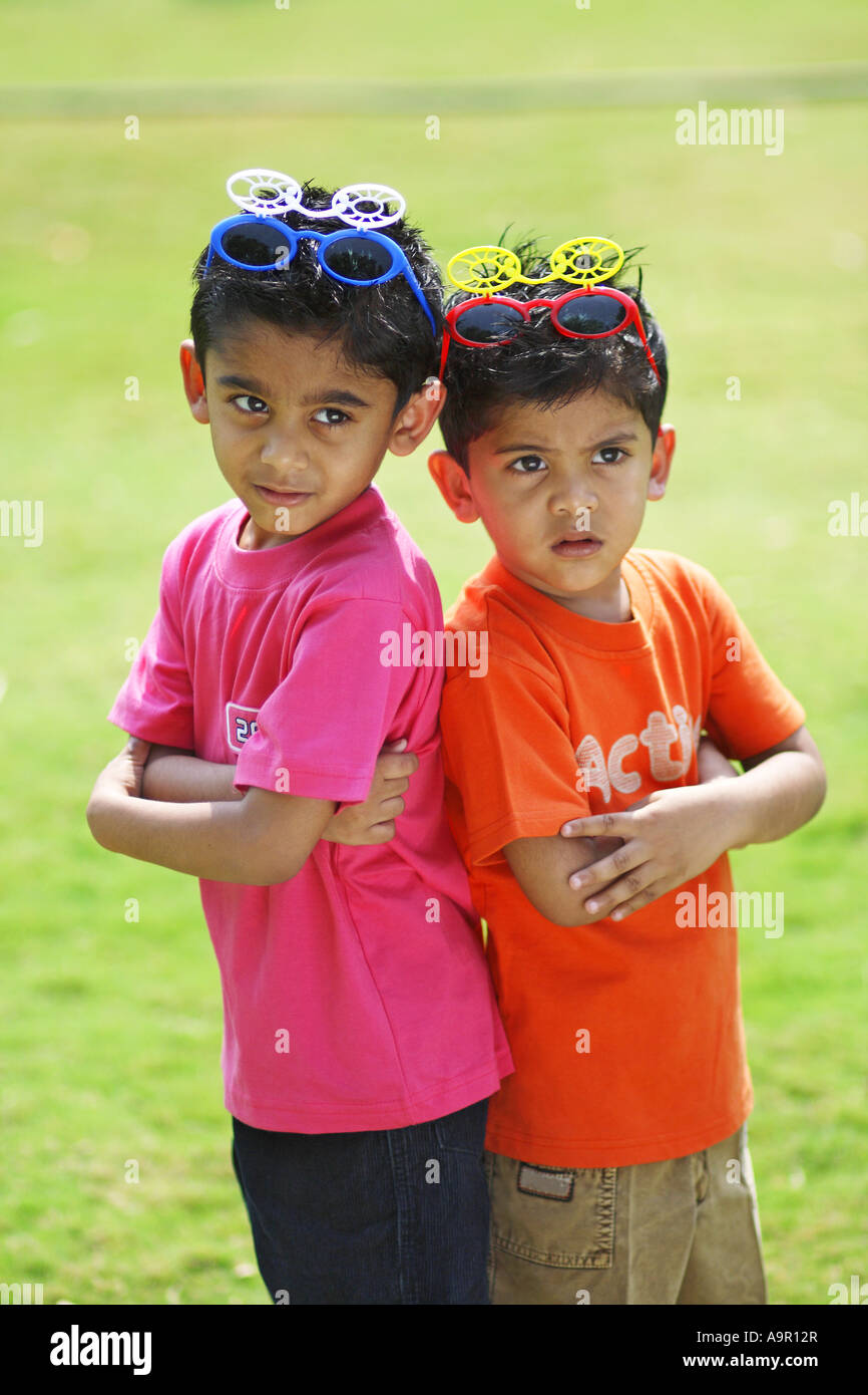 Two kids posing with toy goggles Stock Photo - Alamy