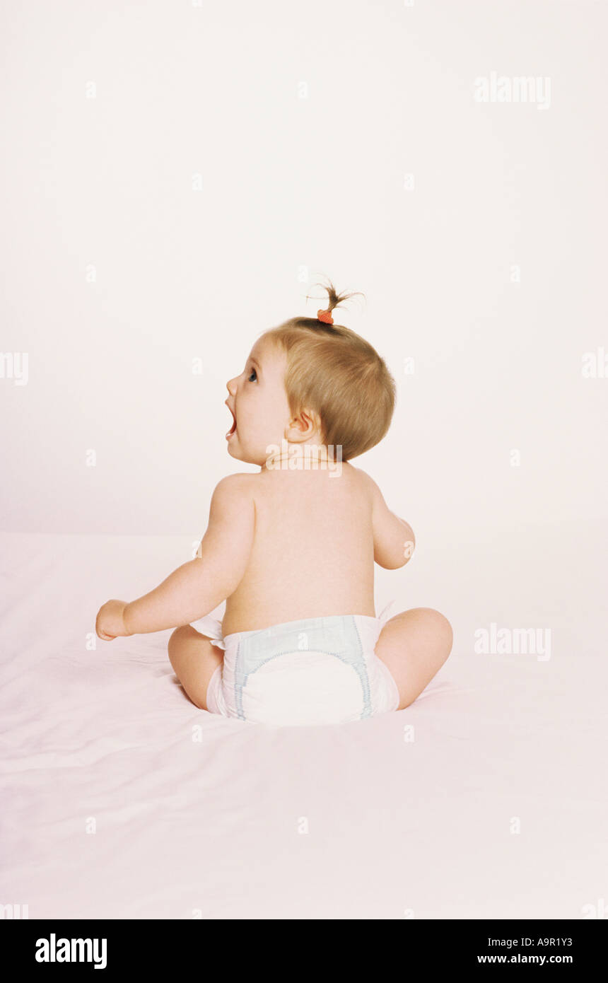 Rear view of baby sitting Stock Photo - Alamy