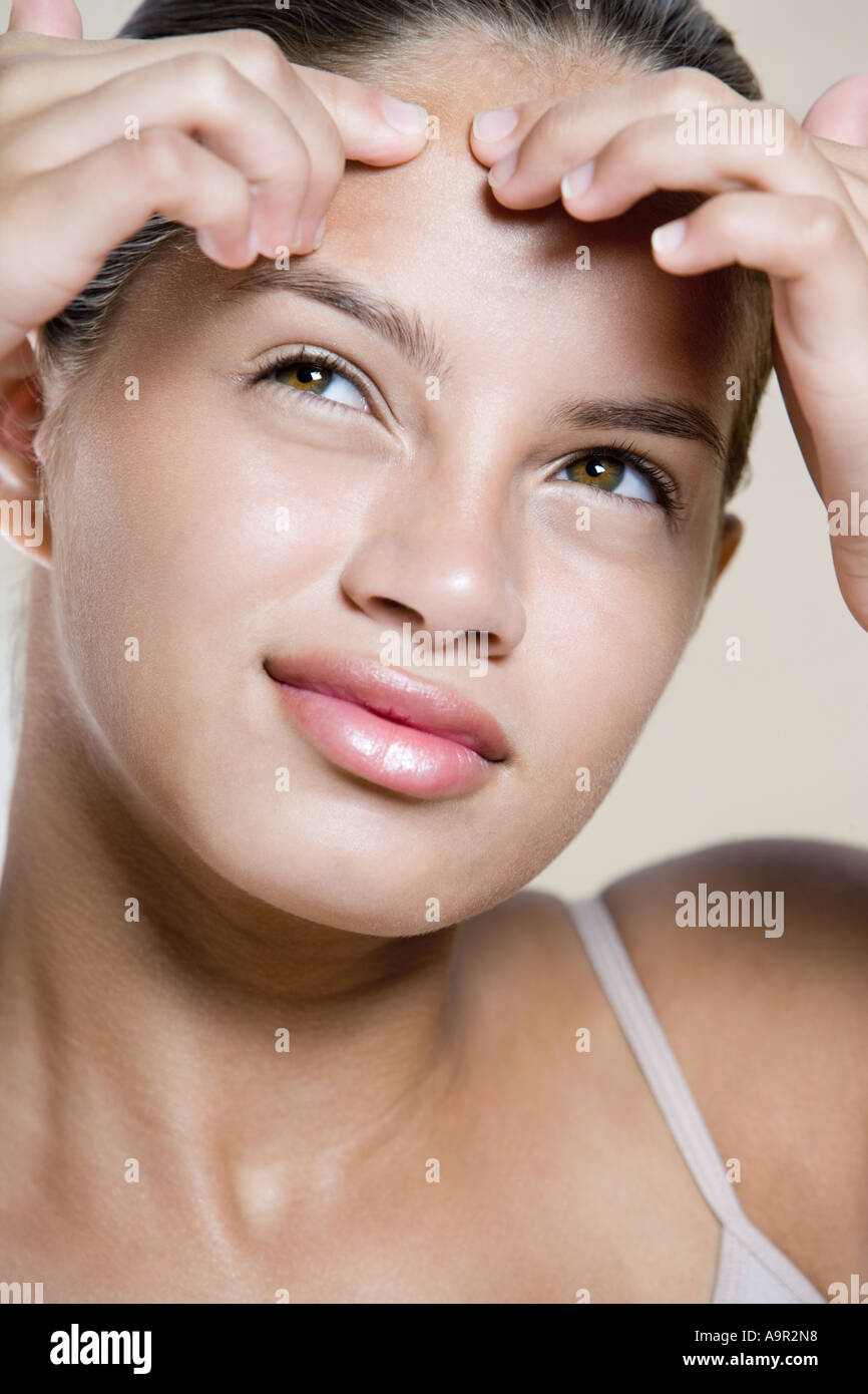 Girl touching her forehead Stock Photo - Alamy Girl touching her forehead Stock Photo - Alamy