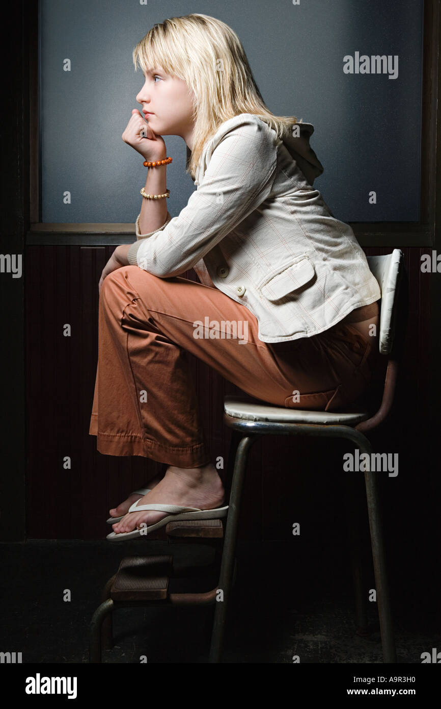 Teenage girl sat alone Stock Photo - Alamy