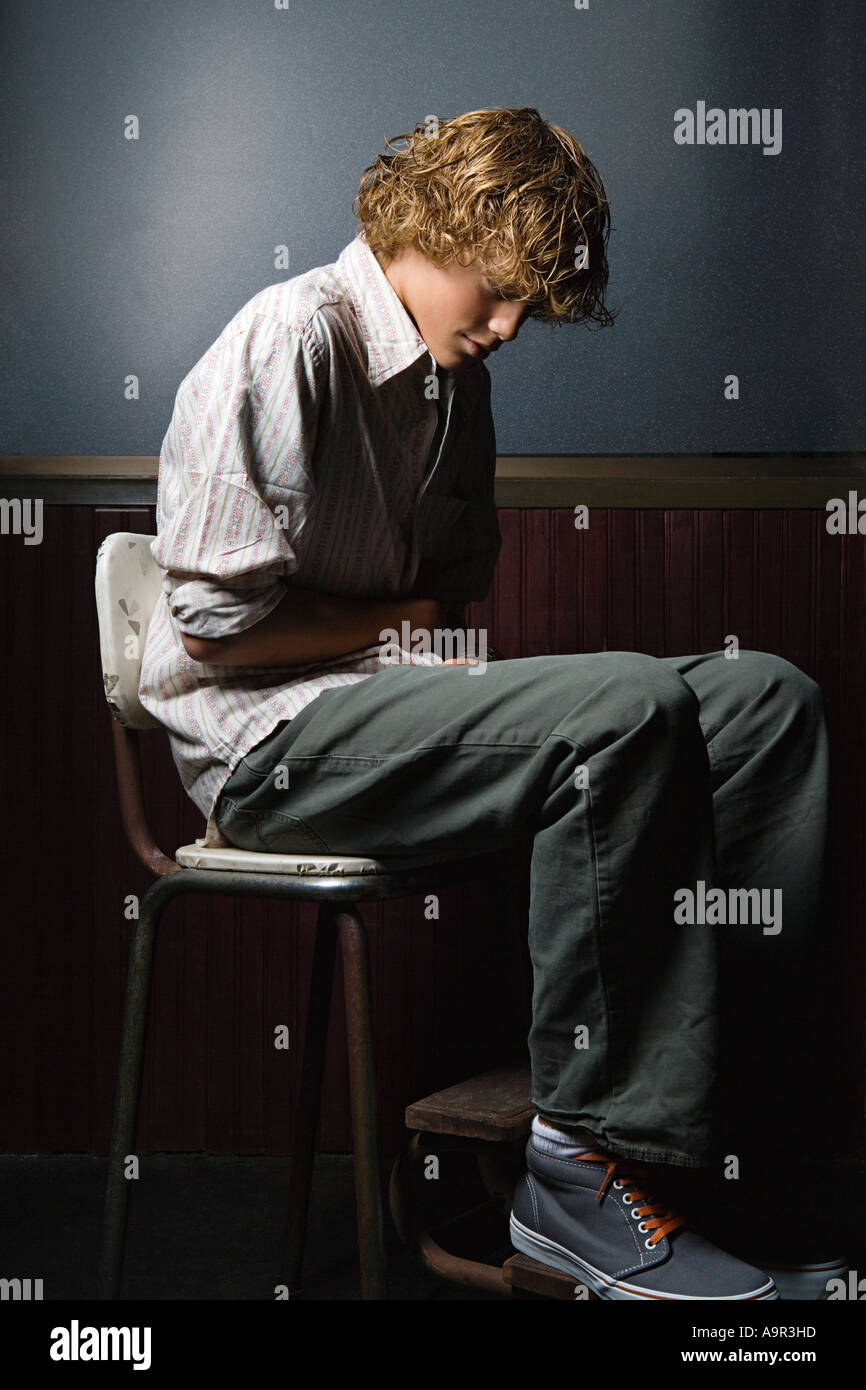 Teenage boy sat alone Stock Photo - Alamy