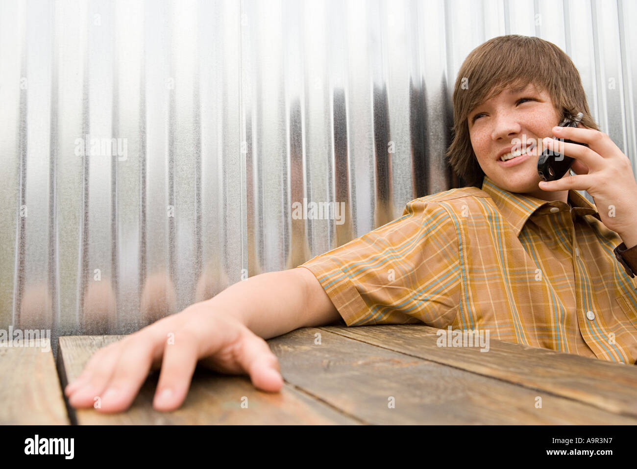 Teenage boy talking on a cellular phone Stock Photo - Alamy