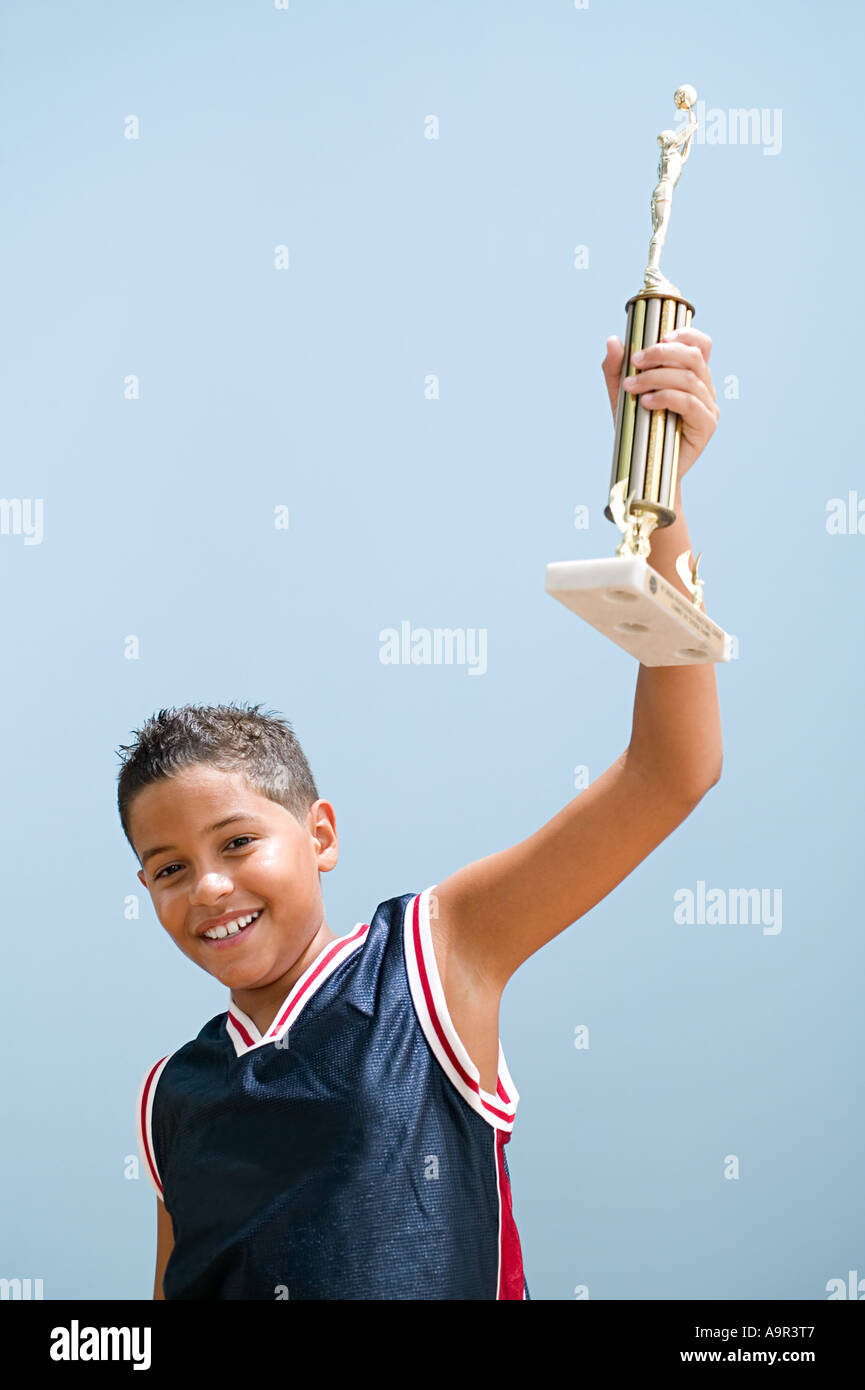 Boy holding up basketball trophy hi-res stock photography and images ...