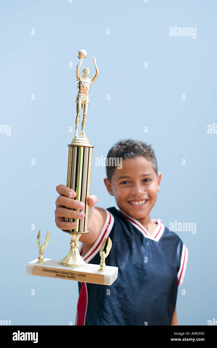 Boy holding up basketball trophy Stock Photo - Alamy