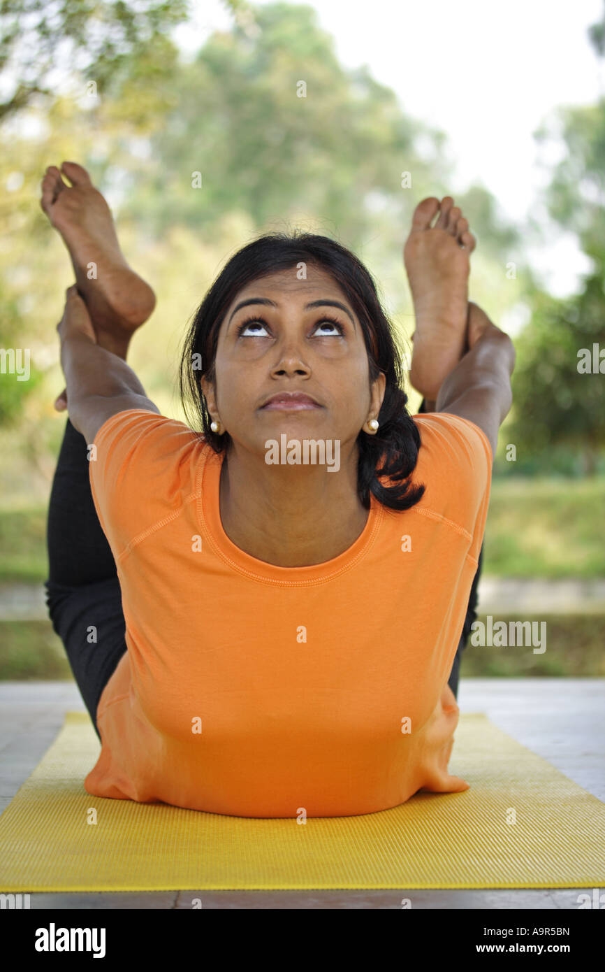 A woman doing yoga exercises Stock Photo - Alamy