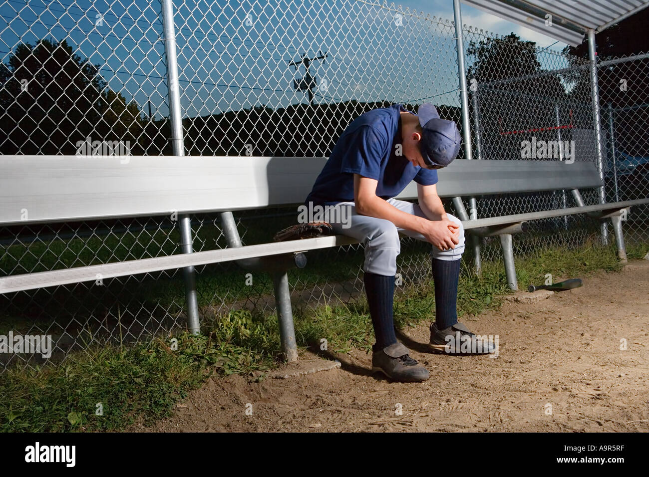 Teenage boy watching from the sidelines Stock Photo - Alamy