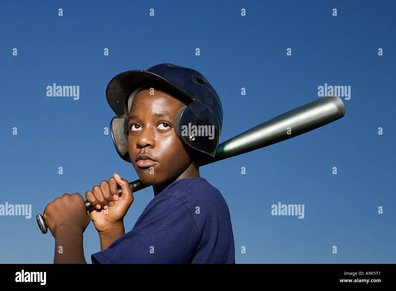 Teenage boy about to swing baseball bat Stock Photo - Alamy