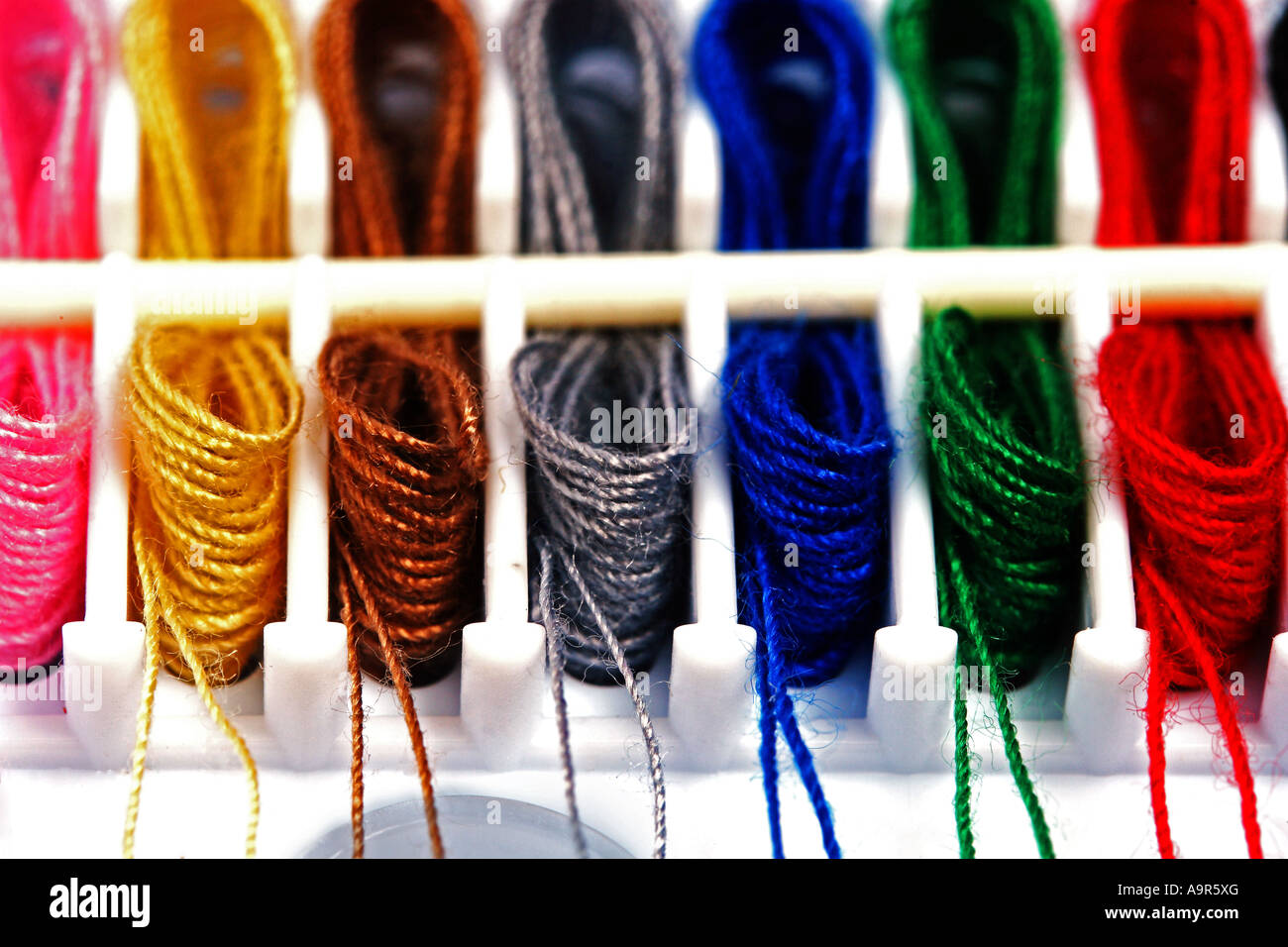 Colourful threads and needles Stock Photo - Alamy