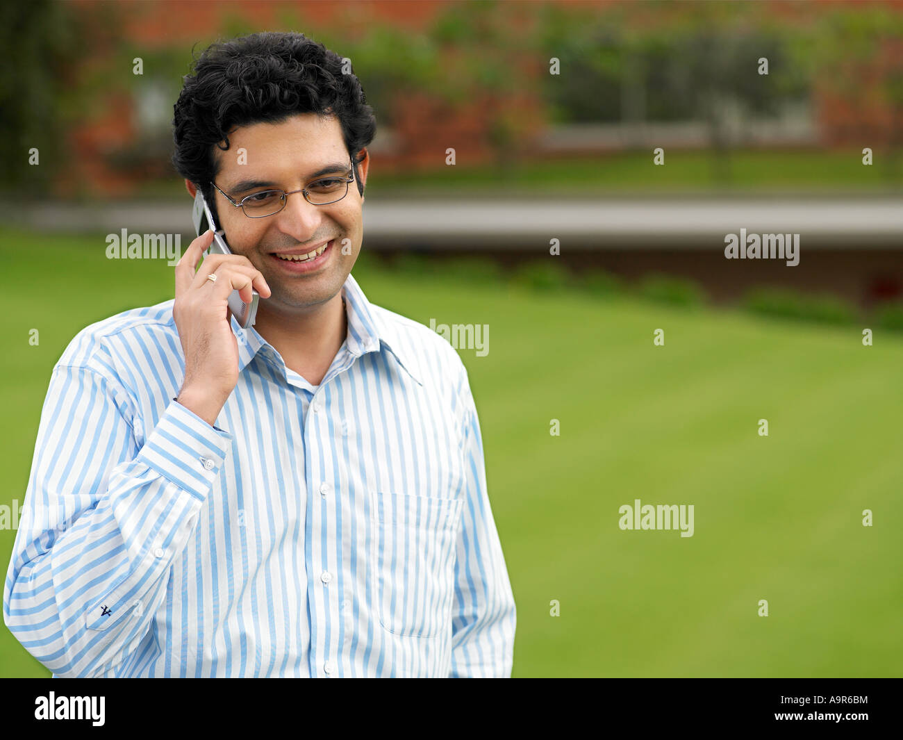A man talking over on a cell phone Stock Photo - Alamy