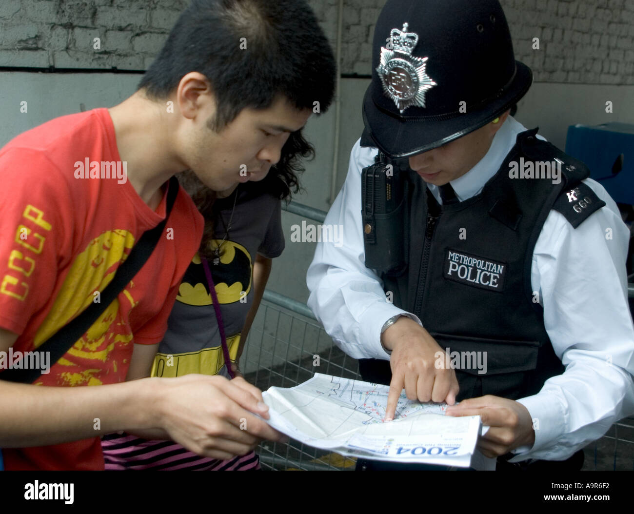 Asian tourists in London asking a policeman for directions, London ...