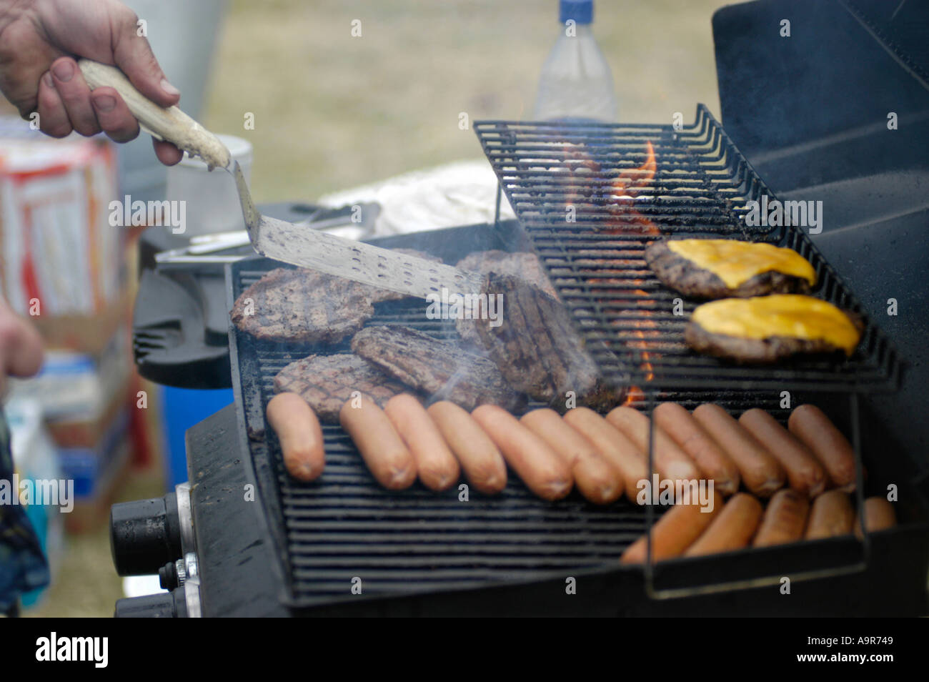Hamburgers and Hotdogs cooking on Bar B Q at Club cookout for kids and ...
