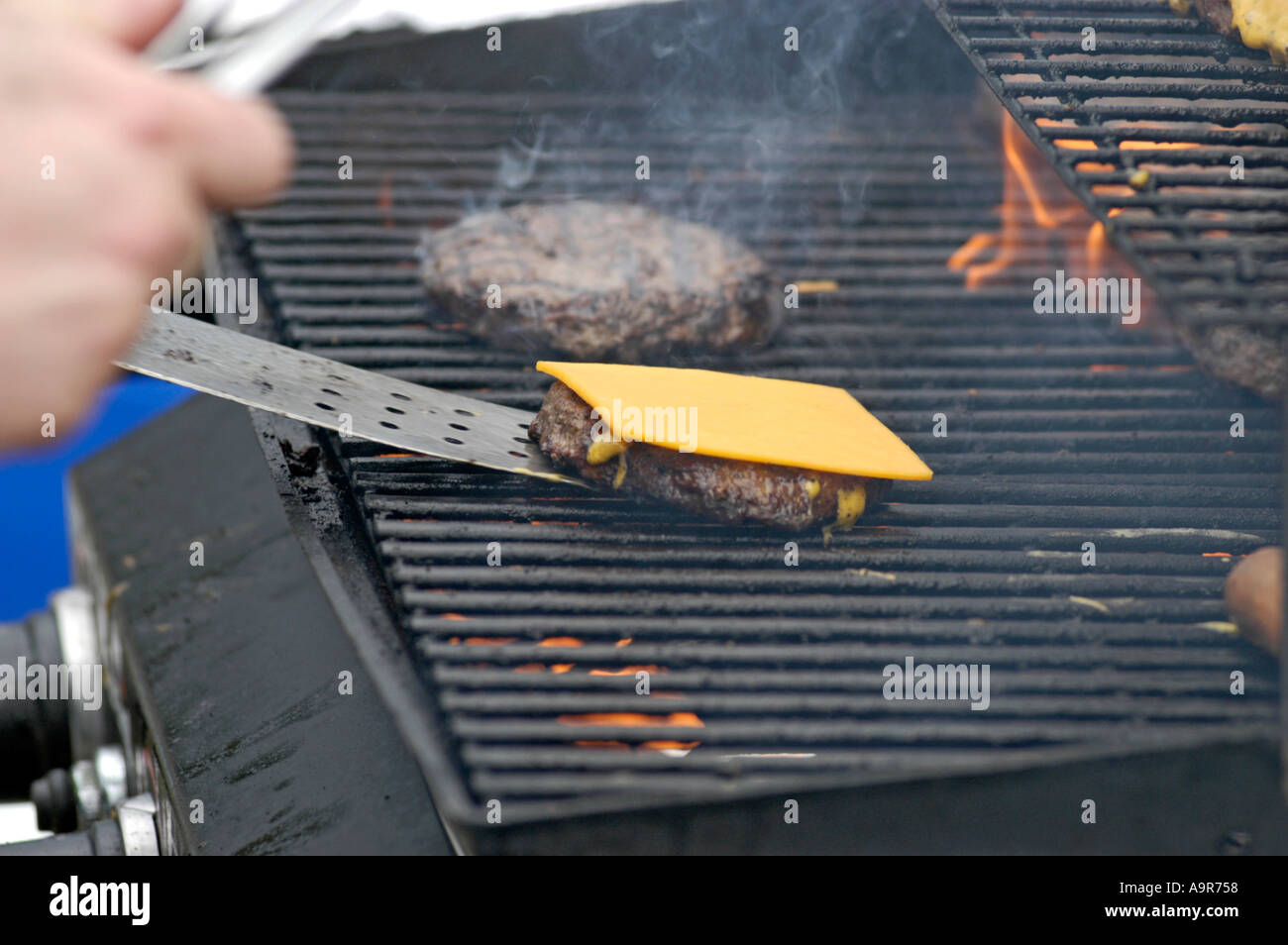 Hamburgers and Hotdogs cooking on Bar B Q at Club cookout for kids and ...