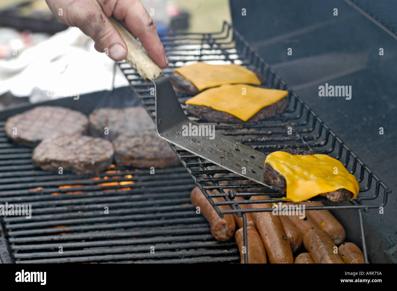 Hamburgers and Hotdogs cooking on Bar B Q at Club cookout for kids and ...