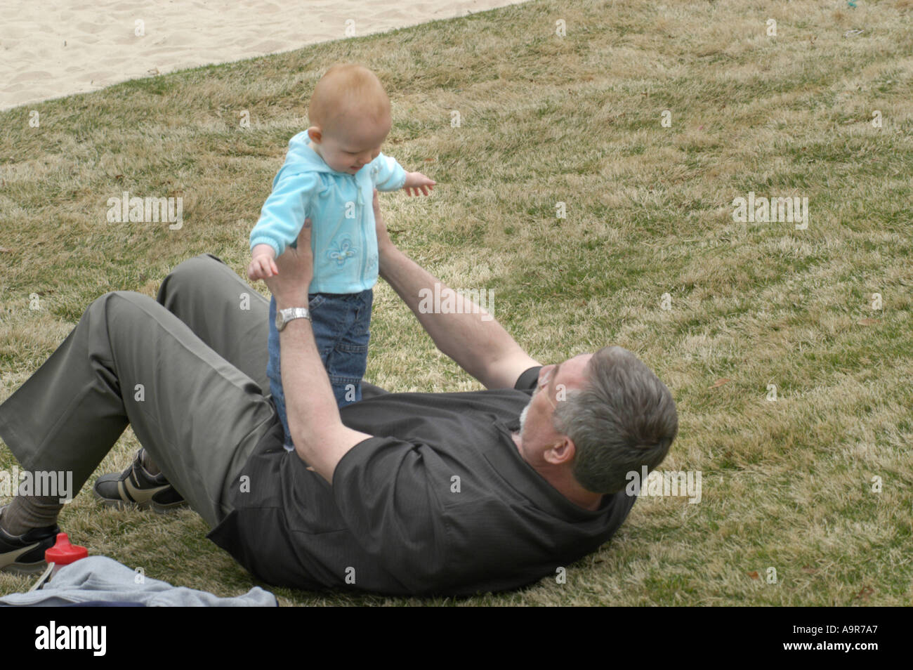 Family on the grass playing on nice day Dad and Son Stock Photo - Alamy