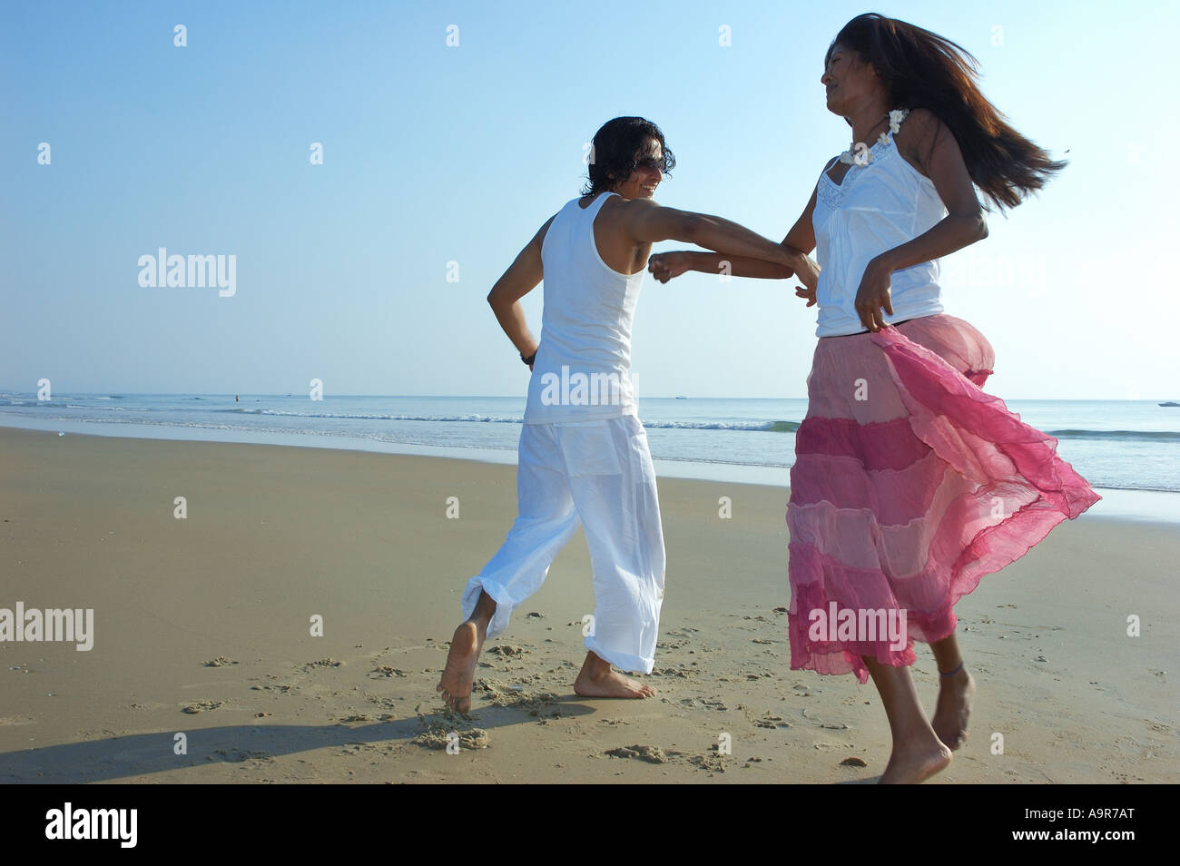 A young couple dancing on a beach Stock Photo - Alamy