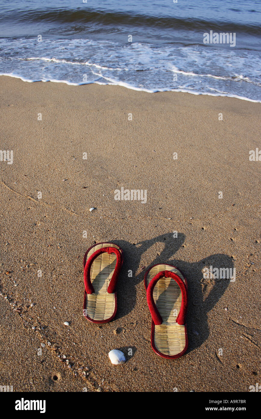 Slippers on the beach Stock Photo - Alamy