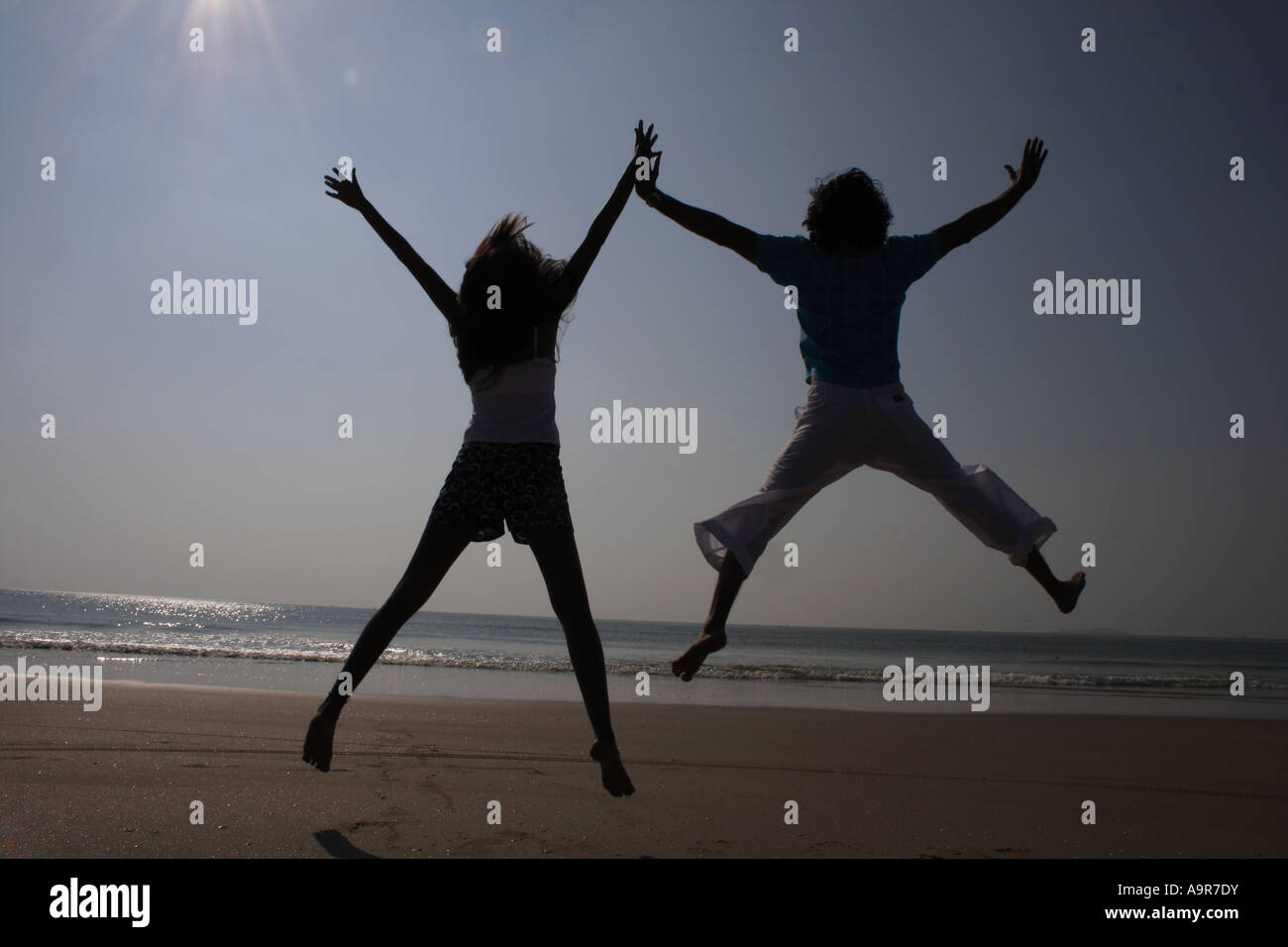Portrait of a couple jumping Stock Photo - Alamy