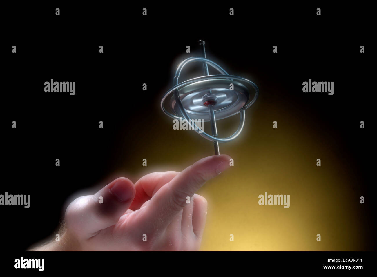 gyroscope balancing on a finger Stock Photo - Alamy