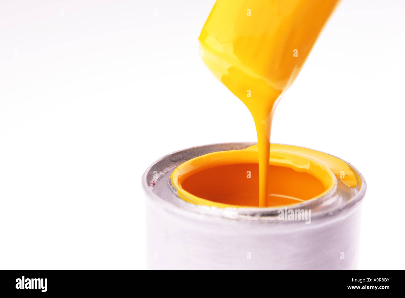 Paint brush dipped in can of yellow paint Stock Photo - Alamy