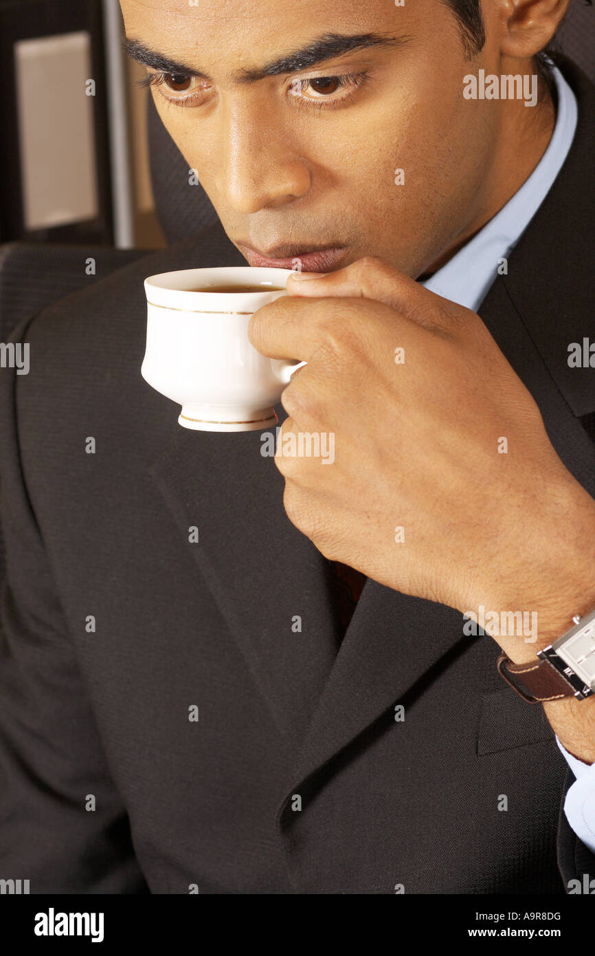 An executive sipping tea Stock Photo - Alamy