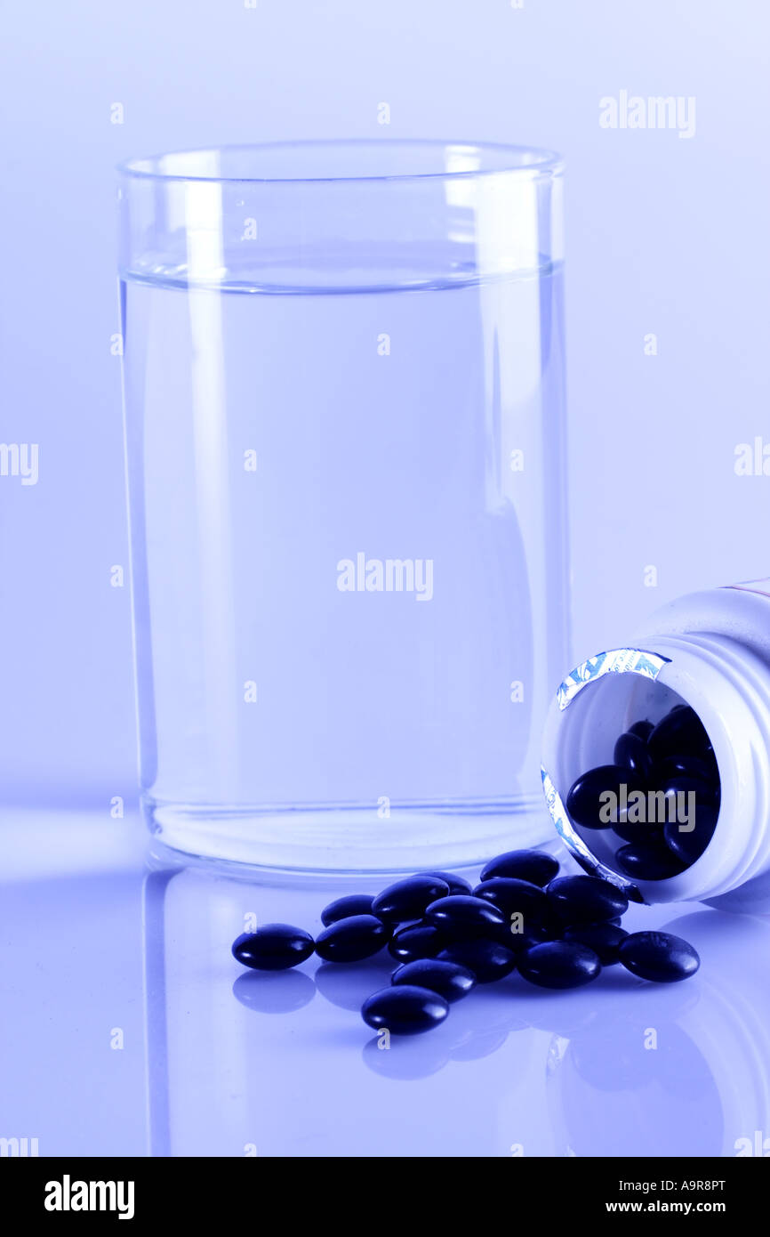 A glass of water with medicine Stock Photo - Alamy