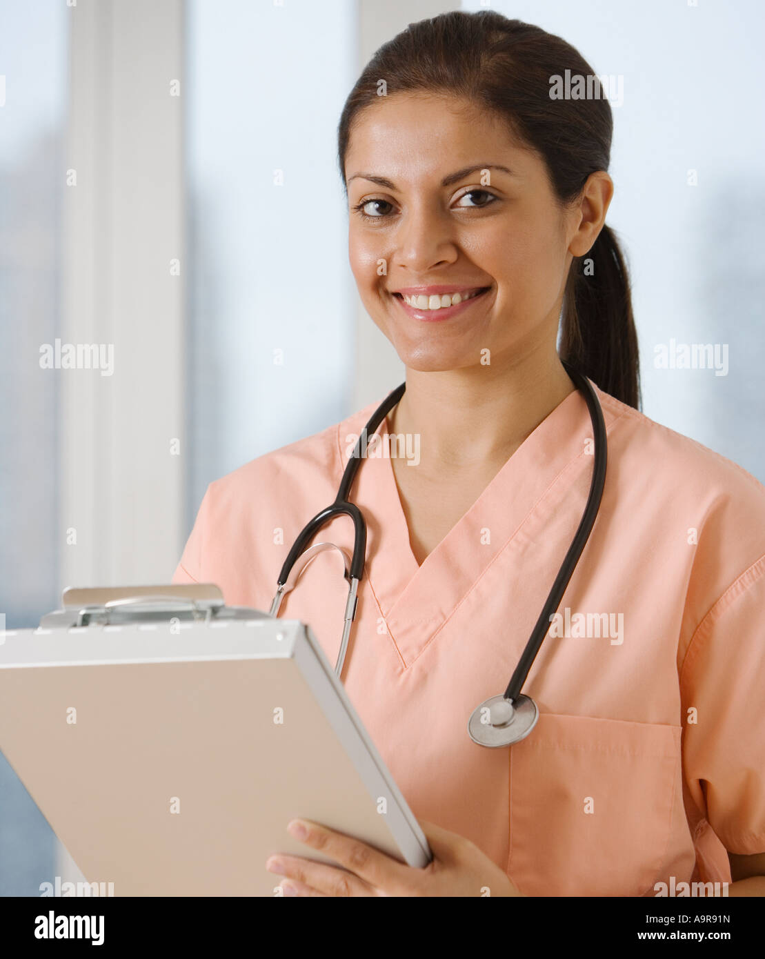 Indian female doctor writing on chart Stock Photo - Alamy