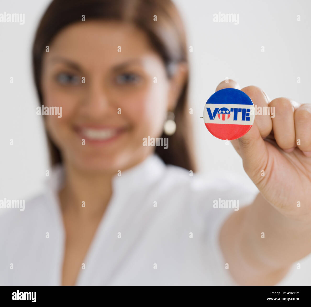 Indian woman holding up Vote pin Stock Photo - Alamy