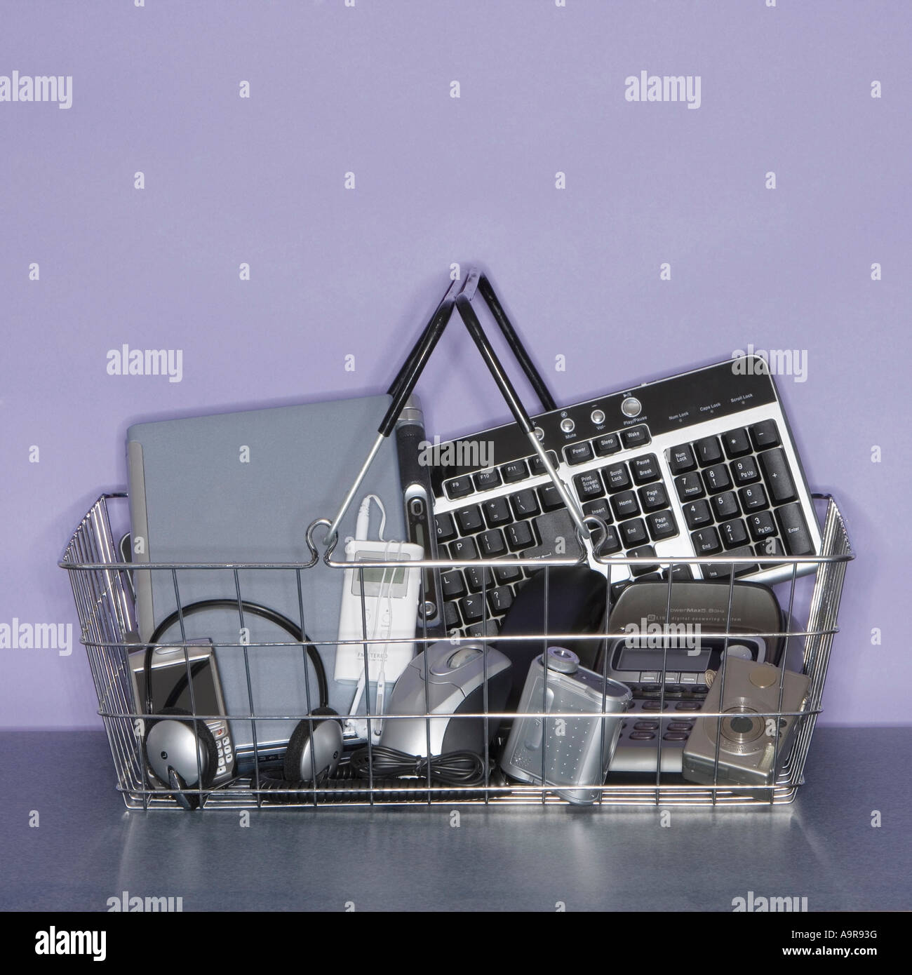 Shopping basket filled with electronics Stock Photo - Alamy