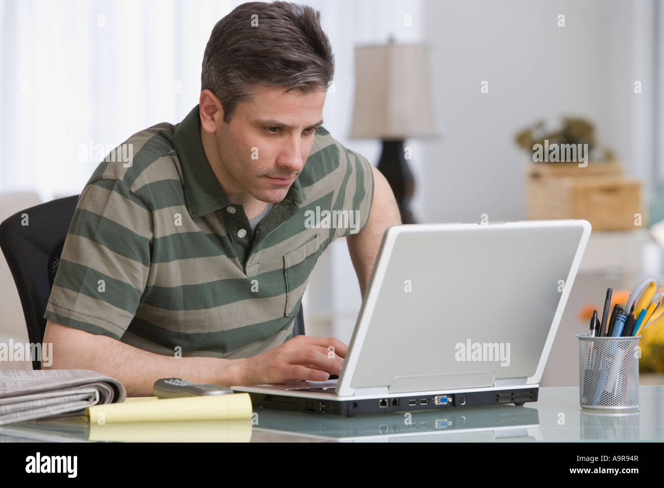 Man looking at laptop Stock Photo - Alamy